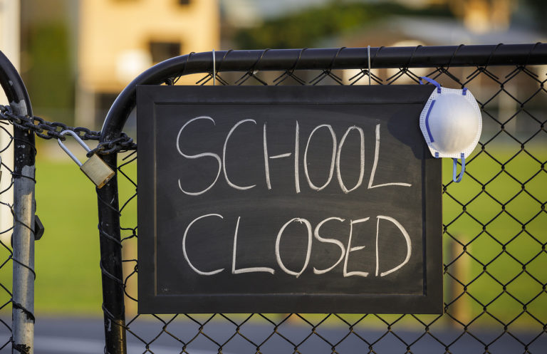 School Closed Sign With Protective Mask Hanging On A Padlocked G ...